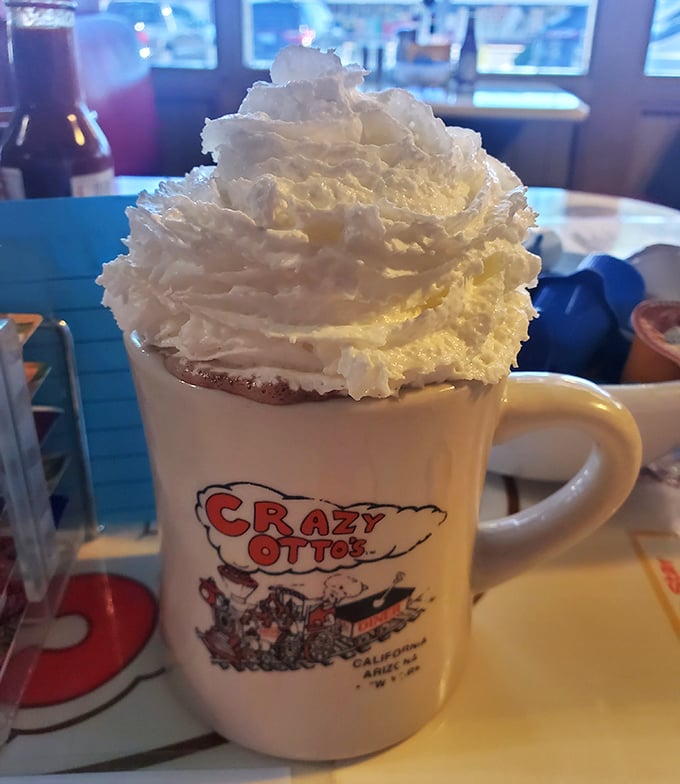 That's not just hot chocolate—that's a cloud of whipped cream performing a balancing act on a mug of liquid comfort.