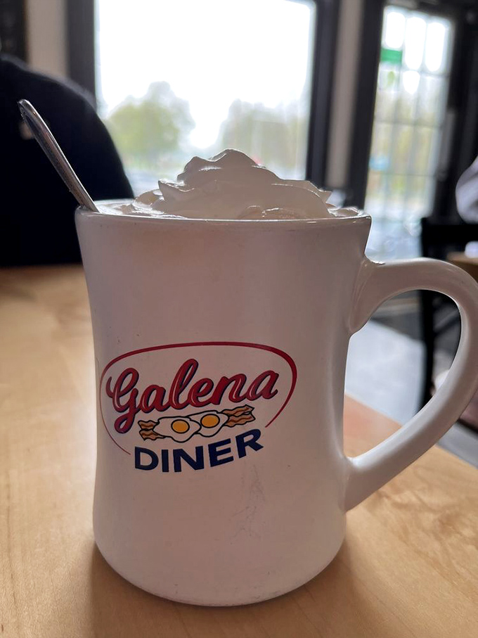 Their signature mug, topped with whipped cream mountain. Coffee tastes 37% better when served in a mug with the diner's logo.