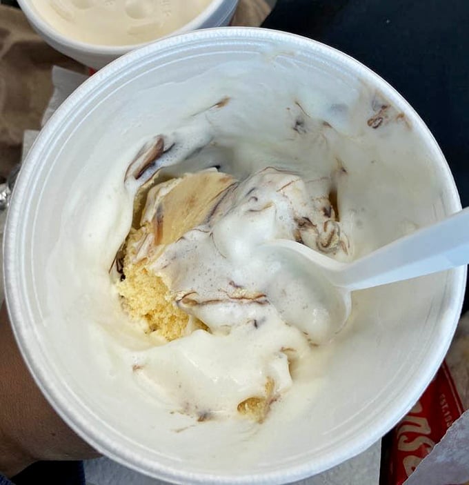 This hot fudge sundae isn't just dessert—it's a swirled masterpiece of vanilla and chocolate that makes you forget you're eating in your car.