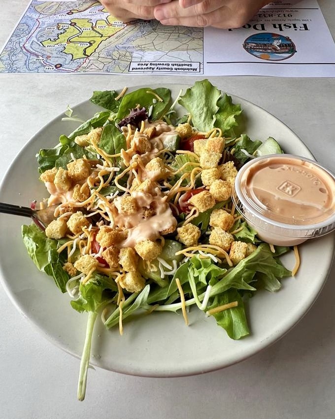 A salad that doesn't apologize for being a salad—fresh greens, cheese, and those croutons that make you wonder if vegetables were just invented as crouton delivery systems.