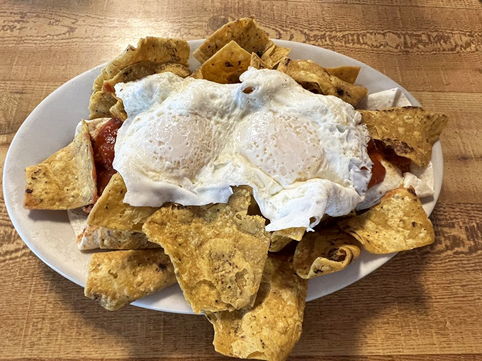 Huevos Rancheros that don't just sit on the plate—they command it, with those perfectly poached eggs standing sentry over a kingdom of tortilla chips.