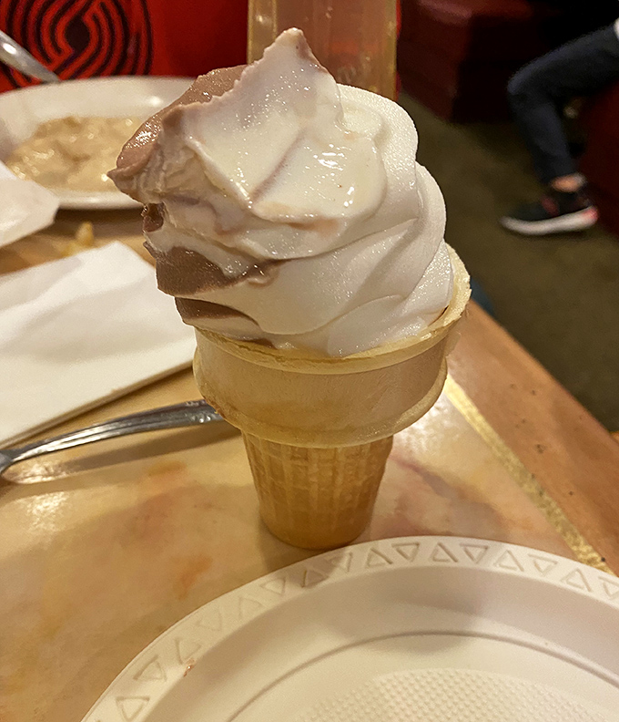 The humble ice cream cone—that perfect finale to a buffet marathon—swirled high with vanilla and chocolate in defiance of all fullness warnings.