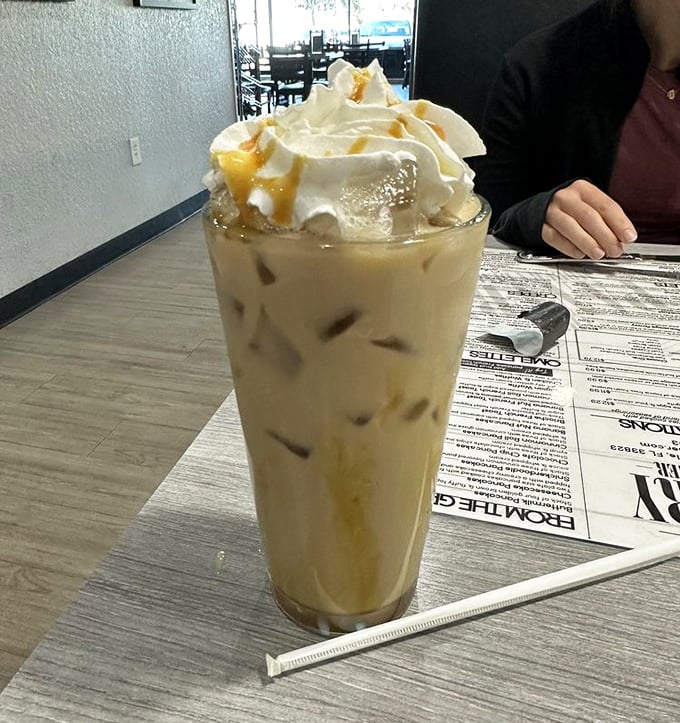 This isn't just iced coffee – it's a caffeinated masterpiece topped with enough whipped cream to make your diet plan file for divorce.