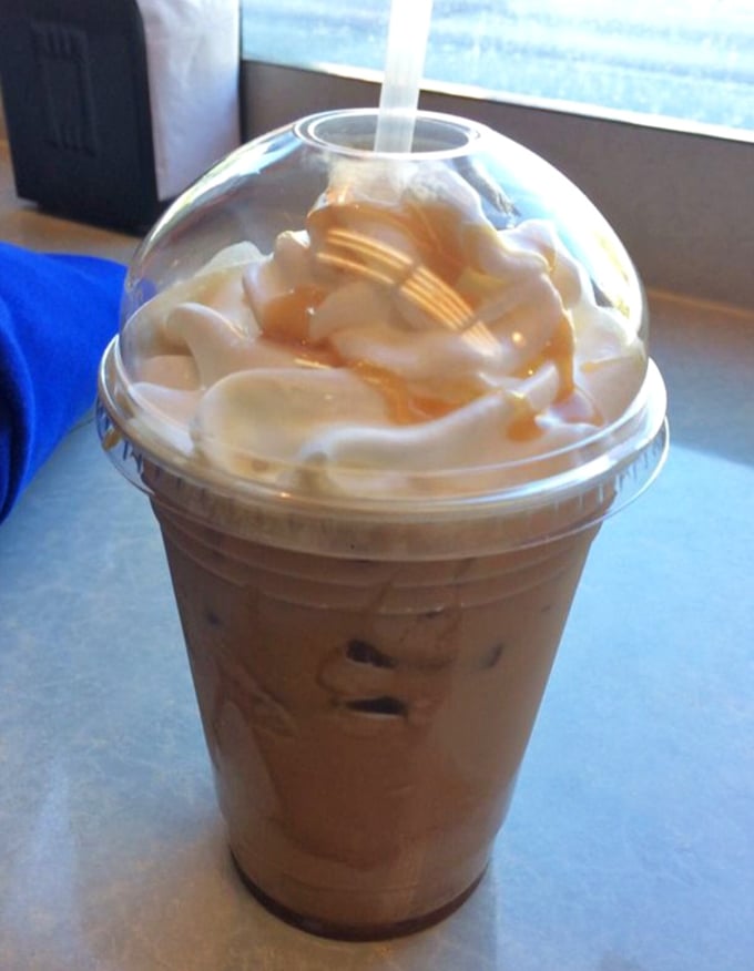 Their caramel latte doesn't need fancy latte art—the whipped cream mountain and caramel rivers speak a universal language of comfort.
