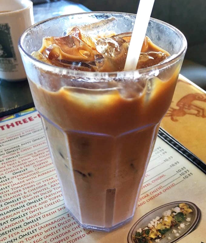 That iced coffee isn't just a beverage—it's your morning superhero, swooping in to save you from the beach heat with caffeinated superpowers.
