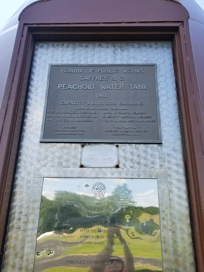 The official plaque reveals the Peachoid's impressive stats: built in 1981, holding one million gallons of water – that's one juicy piece of fruit!