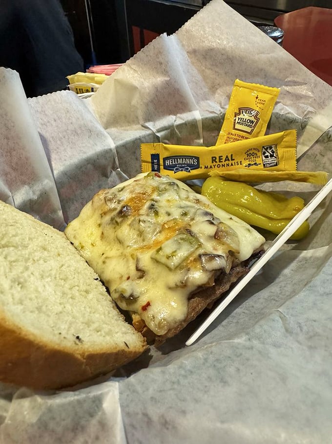 This sandwich isn't just lunch; it's a commitment to excellence. Melted cheese cascading over thinly sliced meat with pickle spears standing guard. 
