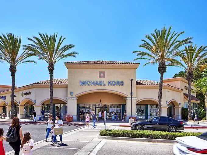 Michael Kors, crowned by royal palms, holds court in the sunshine like a California king of accessible luxury.