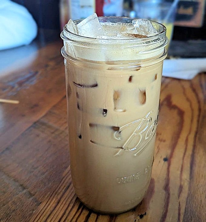 Mason jar coffee that doesn't need fancy Italian names to deliver that morning salvation—just honest brew with a touch of cream.