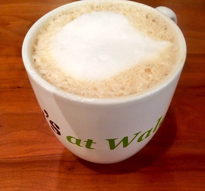 A latte that warms both hands and soul, served in a mug that proudly announces its home. Coffee with a sense of place!