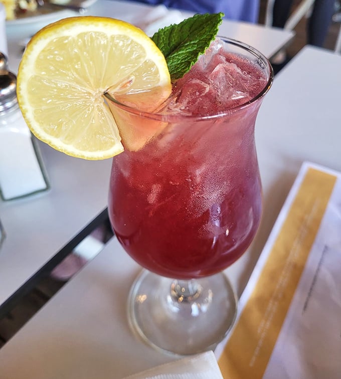 This isn't just any pink lemonade—it's summer in a glass, complete with a slice of sunshine and enough ice to cool your Florida fever.