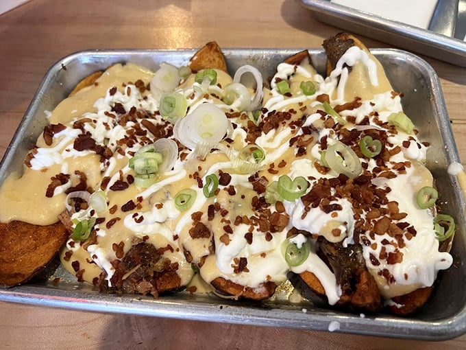 Potato skins elevated to an art form. These aren't your average bar appetizers—they're canvases for BBQ brilliance topped with bacon bits and green onions.
