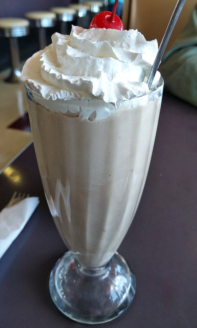 The milkshake that time forgot—topped with real whipped cream and a cherry, it's straight out of a 1950s dream sequence.