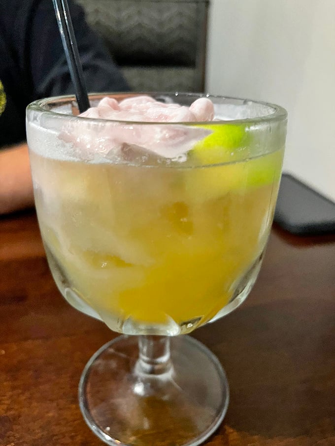 This sunshine-yellow cocktail with a lime garnish isn't just a drink—it's vacation in a glass, no passport required.