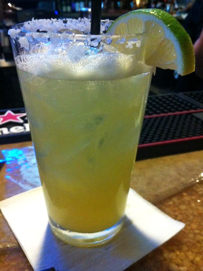 This isn't just a margarita—it's vacation in a glass. The salt-rimmed edge and lime wedge promise a perfect balance of tart, sweet, and spirit.