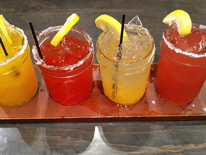 A flight of colorful margaritas with salt-rimmed glasses – because sometimes you need something bright and zingy to cut through all that smoky richness.