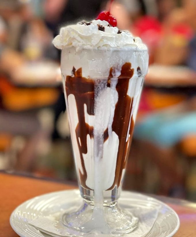 The classic diner milkshake—where chocolate, whipped cream, and cherry come together in a glass vessel of happiness that's worth every brain freeze.
