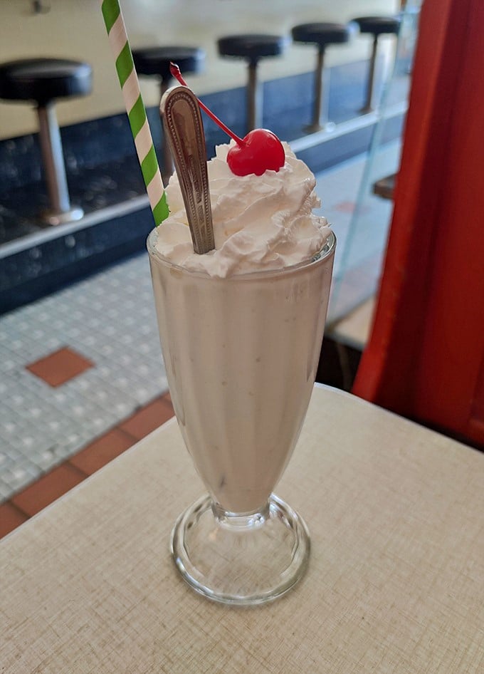 This isn't just a milkshake—it's a frothy time machine topped with whipped cream, a cherry, and a paper straw that actually works.