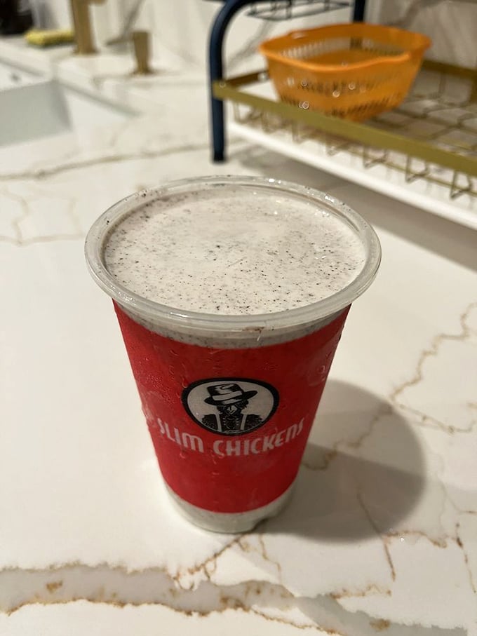 That classic red cup holds liquid happiness—a milkshake thick enough to require serious straw commitment but worth every bit of the effort.