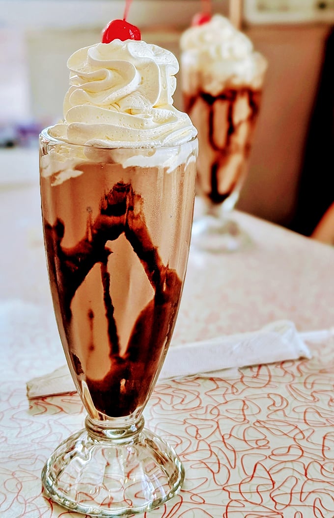This isn't just a milkshake—it's a tower of nostalgia in a glass, where chocolate syrup, ice cream, and whipped cream come together for a standing ovation.