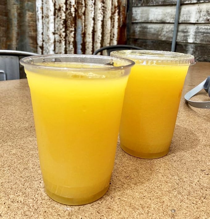 Weekend mimosas served in plastic cups—because sometimes the best champagne experiences come without crystal flutes.