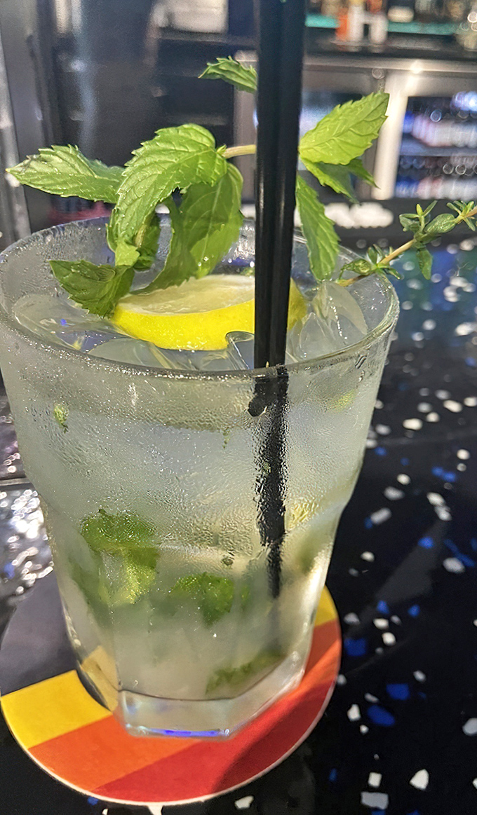 This isn't just a mojito – it's summer in a glass, with fresh mint leaves standing tall like tiny green flags of refreshment.