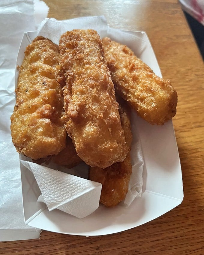 These aren't just mozzarella sticks—they're golden vessels of molten cheese joy, where the satisfying stretch between bite and plate becomes a measure of quality.