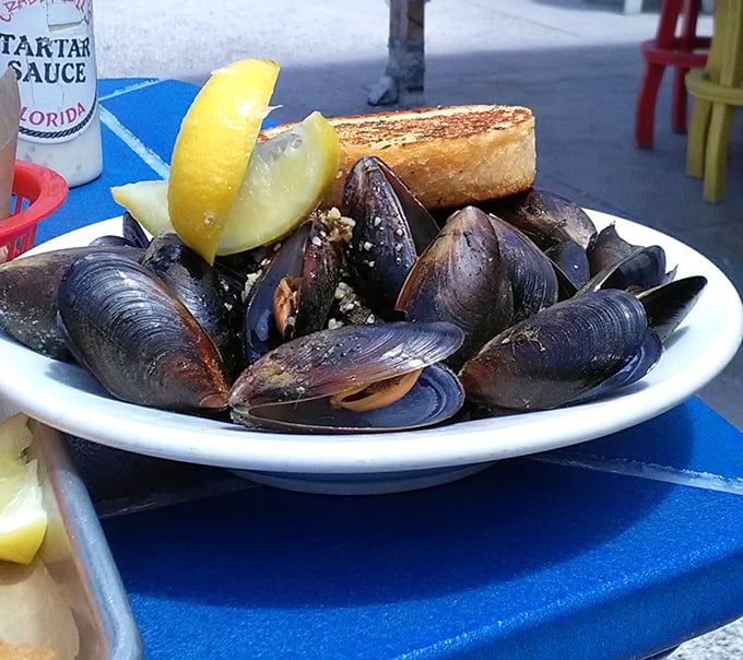 Mussels that have clearly been working out, served with buttery garlic toast perfect for sopping up that can't-waste-a-drop broth.