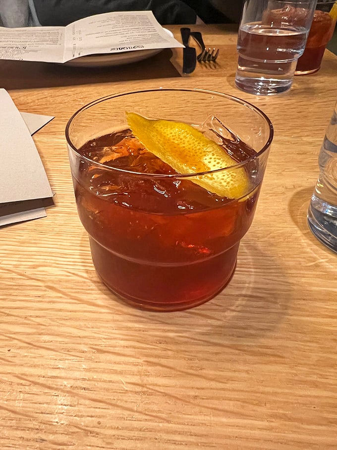 An old fashioned with personality—that citrus peel isn't just garnish, it's an exclamation point on a perfectly balanced cocktail.