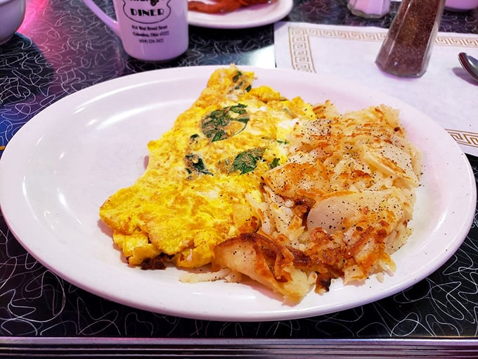 This isn't just an omelet—it's a golden envelope stuffed with a love letter to breakfast, served with crispy potatoes as the perfect PS.