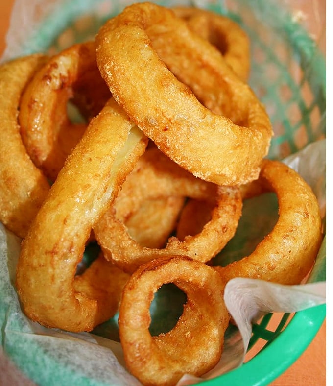 Onion rings with the perfect crunch-to-tenderness ratio—the kind that make you wonder why anyone bothers with fancy appetizers.