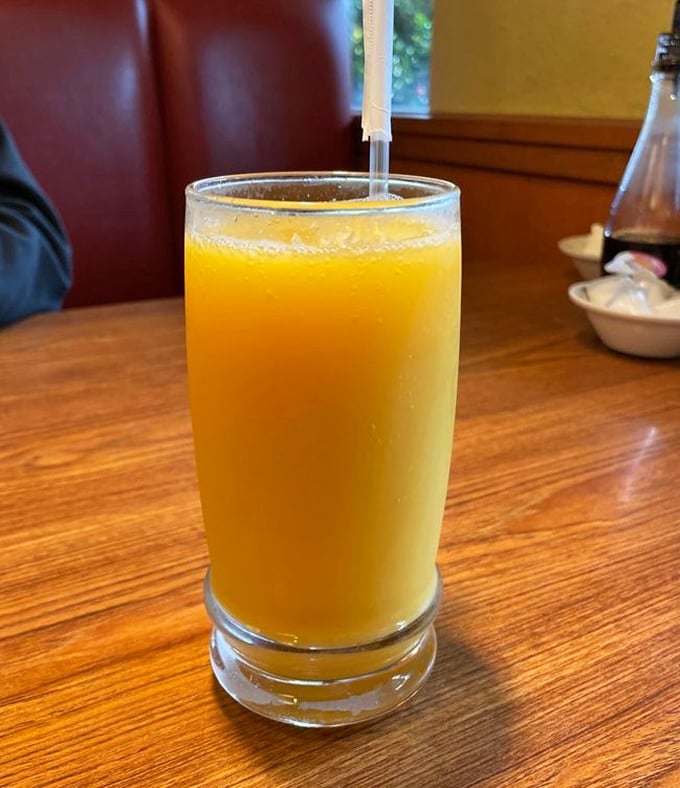 Orange juice in a proper glass – because sometimes vacation breakfast deserves more dignity than a tiny plastic thimble of citrus concentrate.