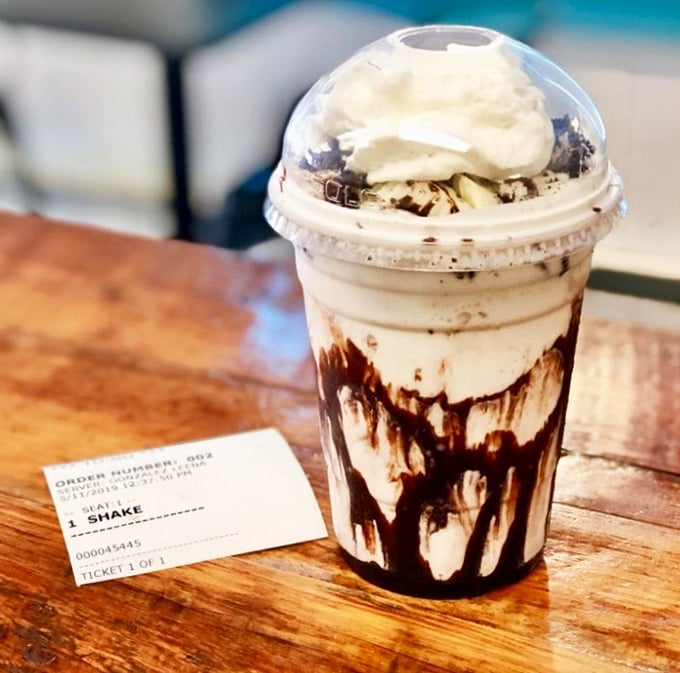 This chocolate shake isn't just a drink—it's a dessert skyscraper with whipped cream clouds and chocolate syrup rainfall.
