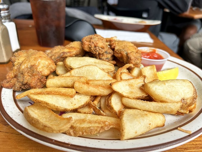 Golden-fried oysters and house-cut potatoes—proof that simplicity, when done right, beats complexity every time. The lemon wedge stands ready for duty.
