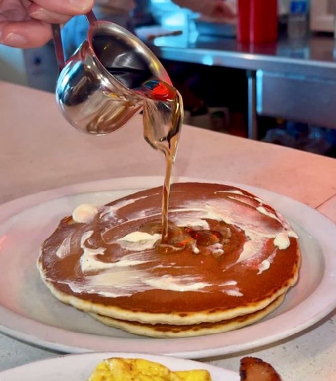 Watch as liquid gold cascades over a perfect pancake – a moment of breakfast theater that never fails to quicken the pulse.