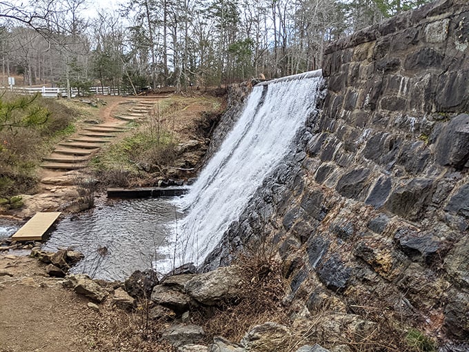 The stone dam's cascading waters create a hypnotic visual that's worth pulling over for – nature's version of meditation in motion.