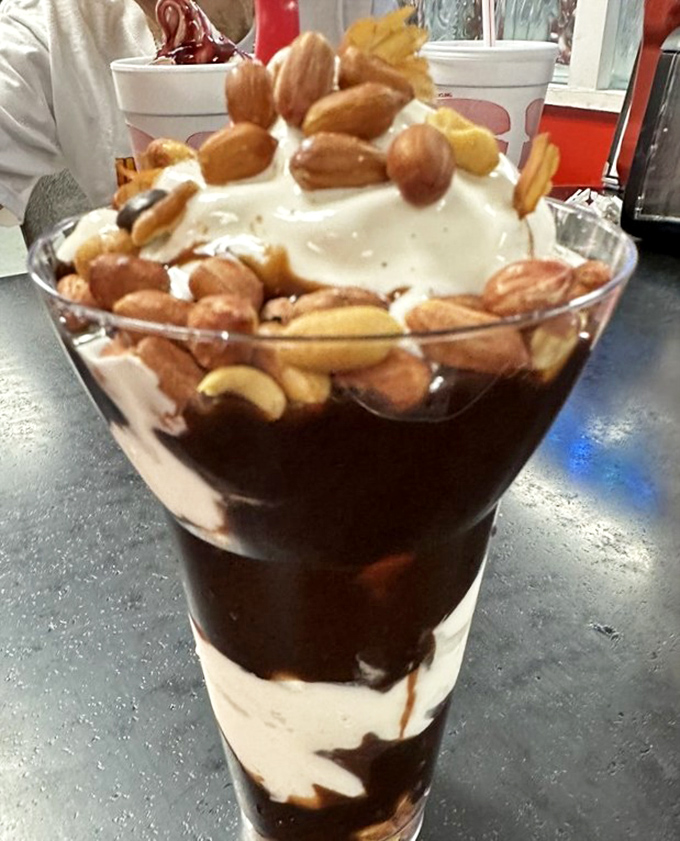 Not just a parfait—it's a stratified archaeological dig through layers of chocolate, cream, and nuts that Indiana Jones would happily explore.
