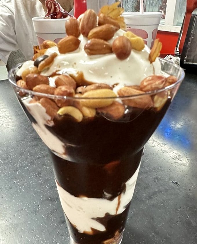Not just a parfait—it's a stratified archaeological dig through layers of chocolate, cream, and nuts that Indiana Jones would happily explore.