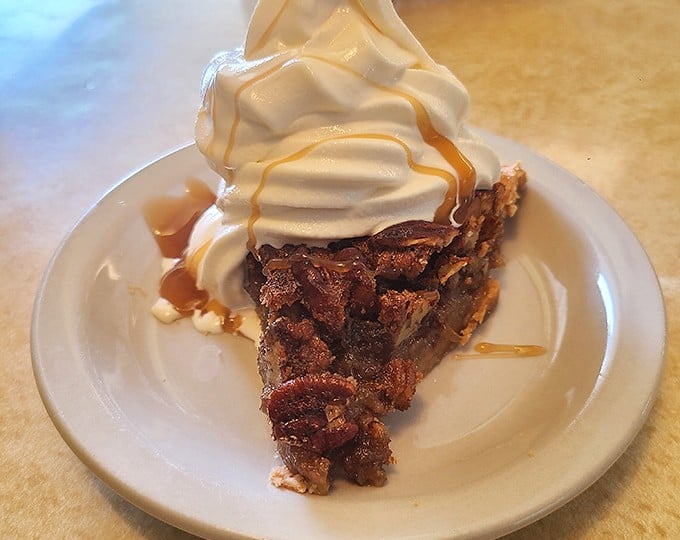 Pecan pie topped with a cloud of whipped cream – the kind of dessert that makes you wonder why anyone bothers with molecular gastronomy.