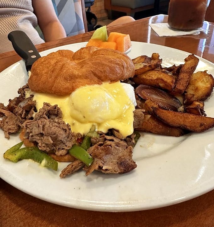 Breakfast architecture at its finest – a croissant Benedict featuring Philly steak that makes you wonder why you ever settled for plain English muffins.