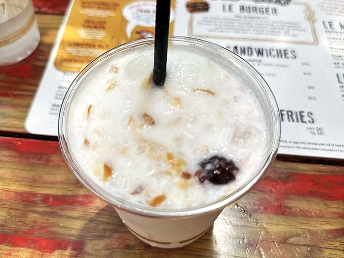 The piña colada arrives looking like a tropical vacation in a cup – creamy, cold, and capable of making you forget whatever troubles followed you here.
