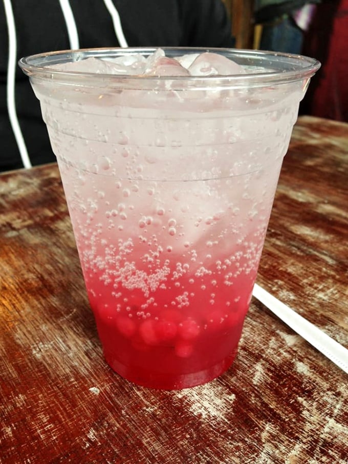 That vibrant red beverage isn't just a drink—it's liquid refreshment art, bubbling with possibilities and the perfect counterpoint to biscuit richness.