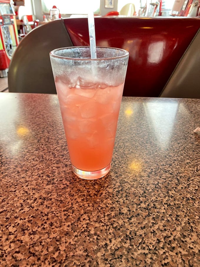 That pink lemonade isn't just a drink—it's summer in a glass, offering sweet-tart refreshment between bites of diner perfection.
