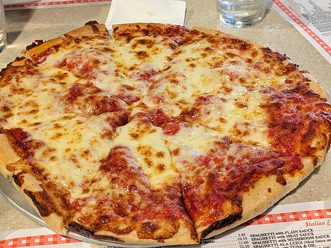 Pizza perfection isn't complicated: a thin, crispy-yet-chewy crust, bright tomato sauce, and a blanket of molten cheese that stretches dramatically with each slice.