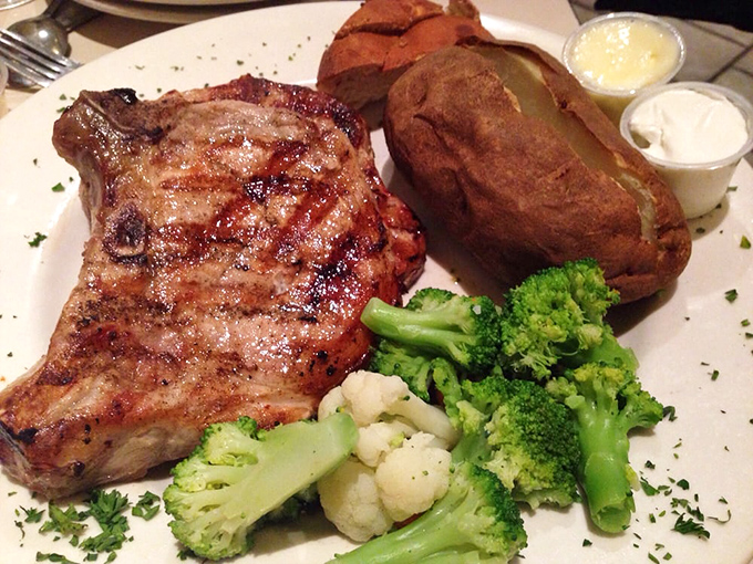 This pork chop isn't just cooked, it's respected – served alongside vegetables that weren't merely an afterthought but worthy companions.
