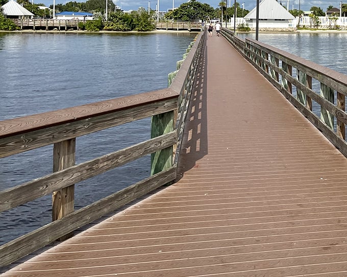 This boardwalk stretches into possibility – a wooden runway where pelicans are the supermodels and everyone walks at the perfect Florida pace: unhurried.