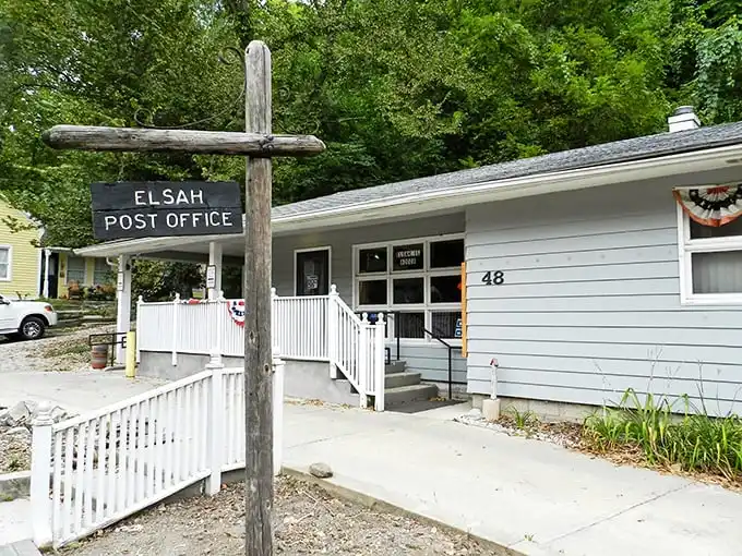 Neither snow nor rain nor gloom of night... The Elsah Post Office sign stands tall, a rustic landmark in this riverside time capsule.
