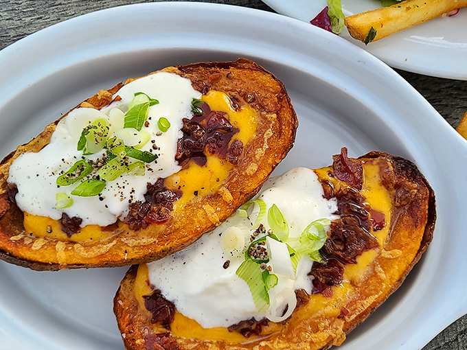 Potato skins elevated from bar food to culinary delight – crispy vessels loaded with melty cheese and topped with fresh scallions.