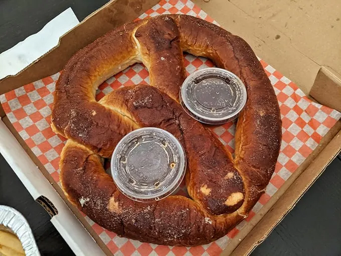 This pretzel could double as a life preserver, twisted into golden perfection with mustard standing guard.