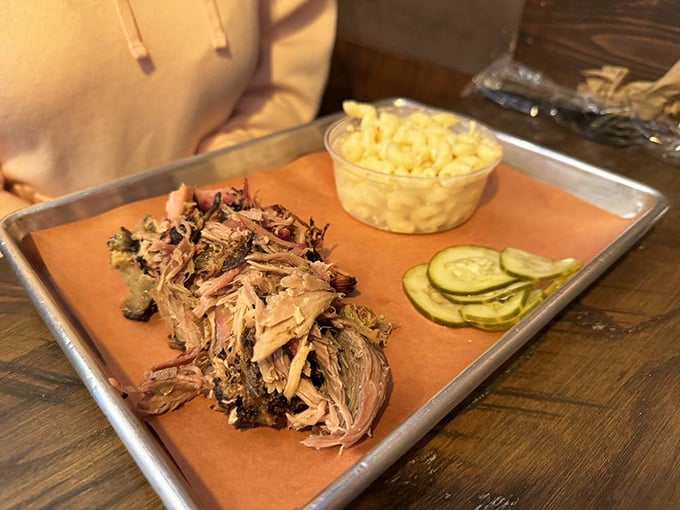 Pulled pork lounging next to mac and cheese like old friends catching up over comfort food.